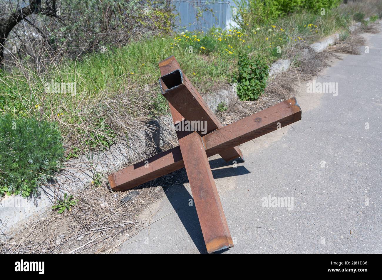 Anti-tank obstacles in the street of a Ukrainian city. Metal barrier ...