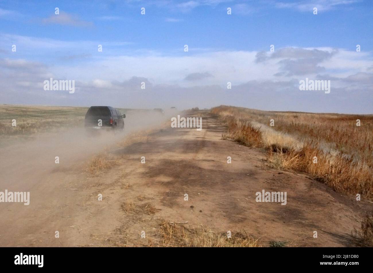 SUV automobile creating dust on dirt road in agricultural field Stock ...