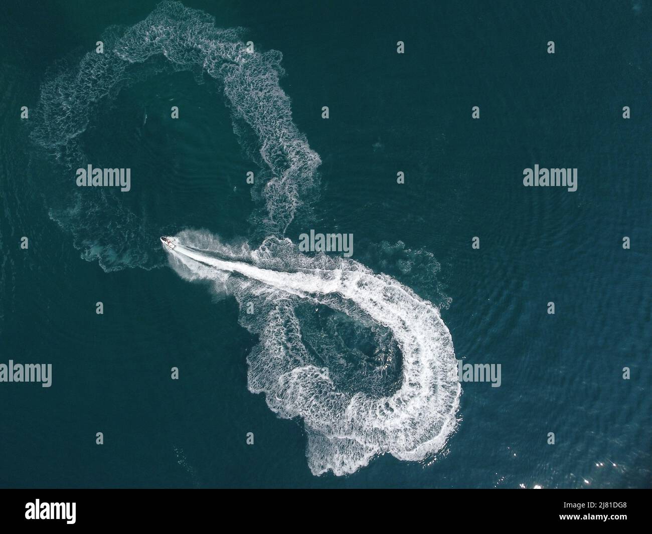 Aerial top down view of water foam trace with nice deep blue shade of ...