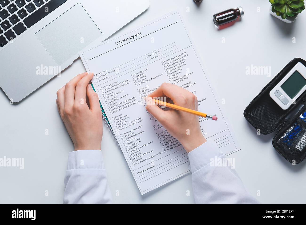 Female doctor writing in laboratory test form on white background Stock ...