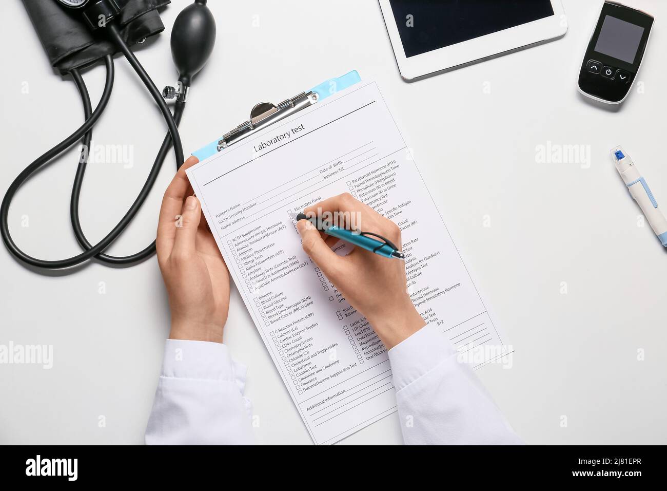 Female doctor writing in laboratory test form on white background Stock ...