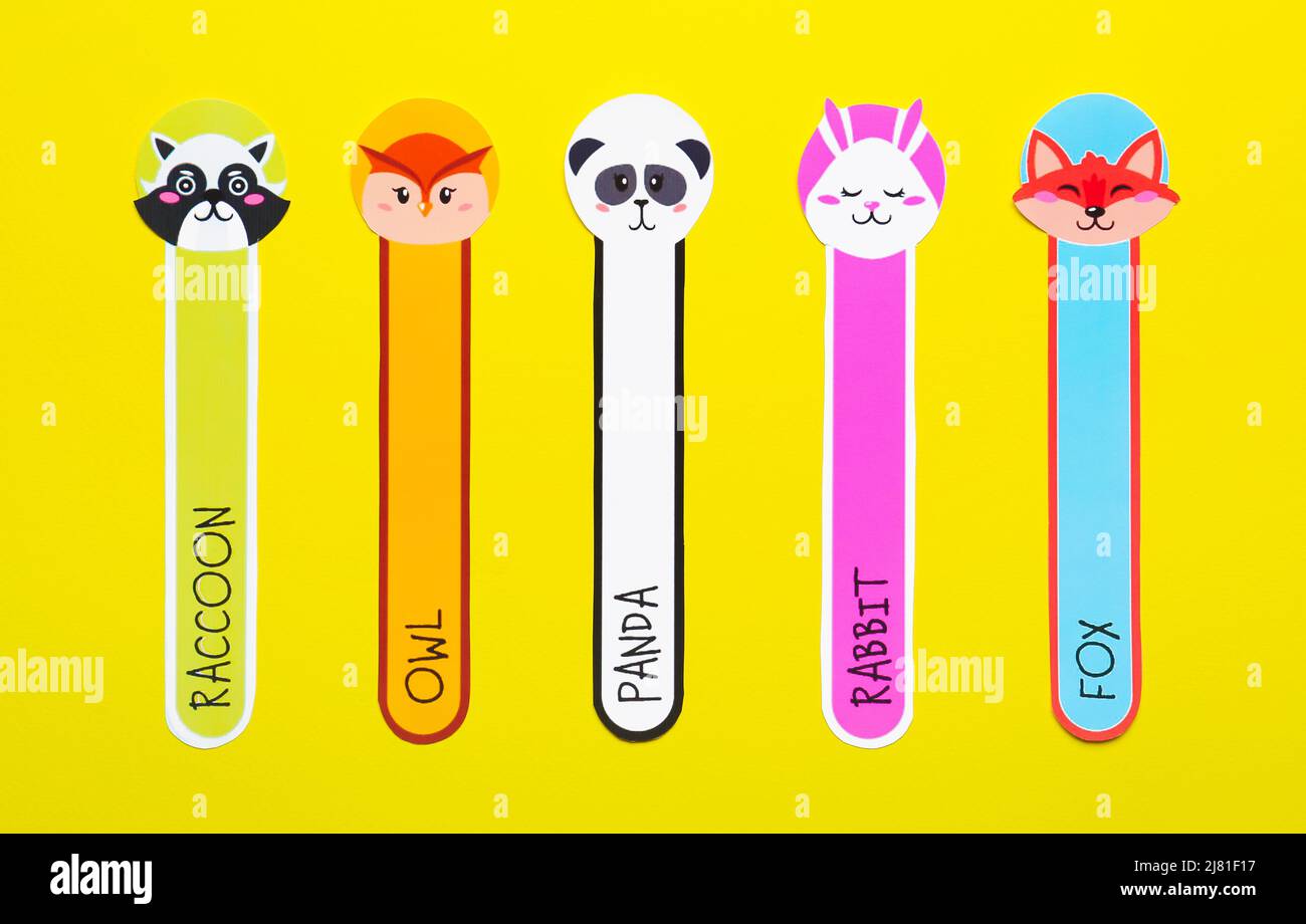 Different cute bookmarks on yellow background Stock Photo - Alamy