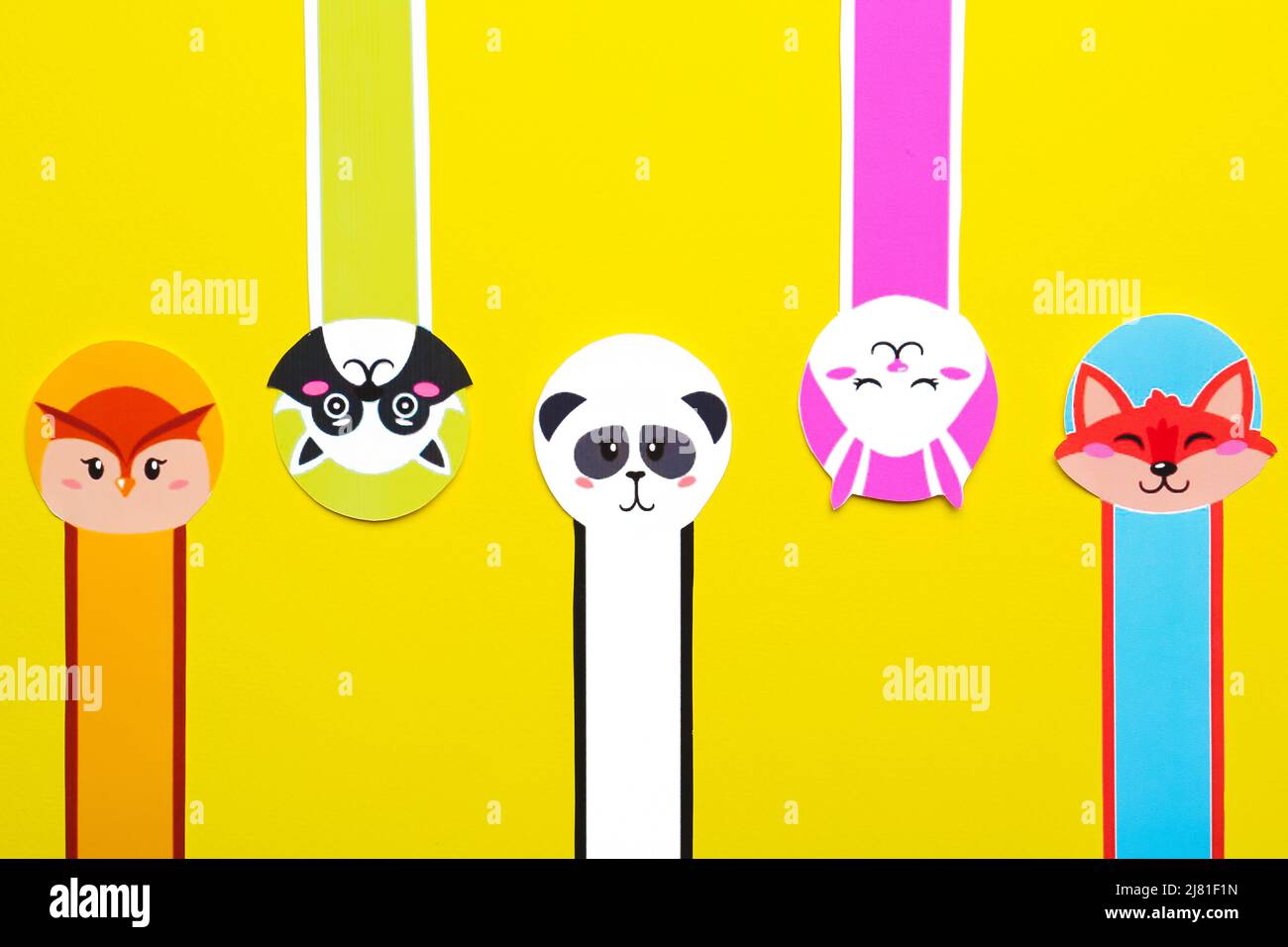 Different cute bookmarks on yellow background Stock Photo - Alamy