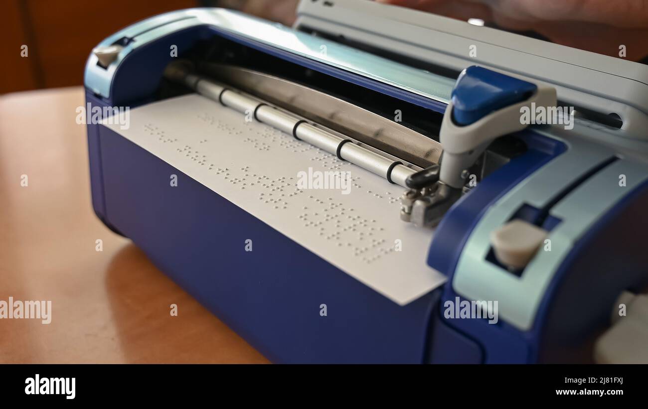 Blind man using braille typewriter Stock Photo - Alamy