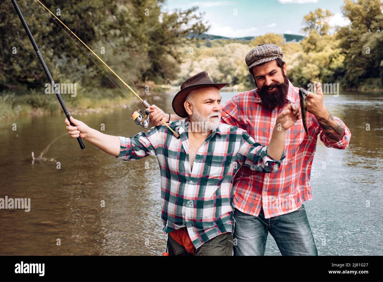 Fisherman men friends and trophy trout. Father and son fishing ...