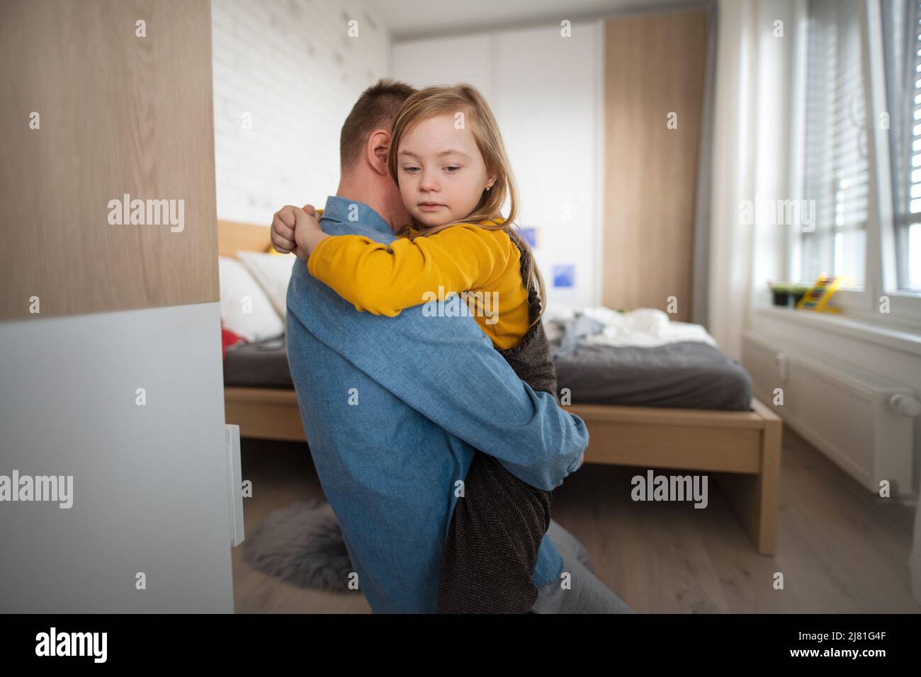 Father hugging his little daughter with Down syndrome at home Stock ...
