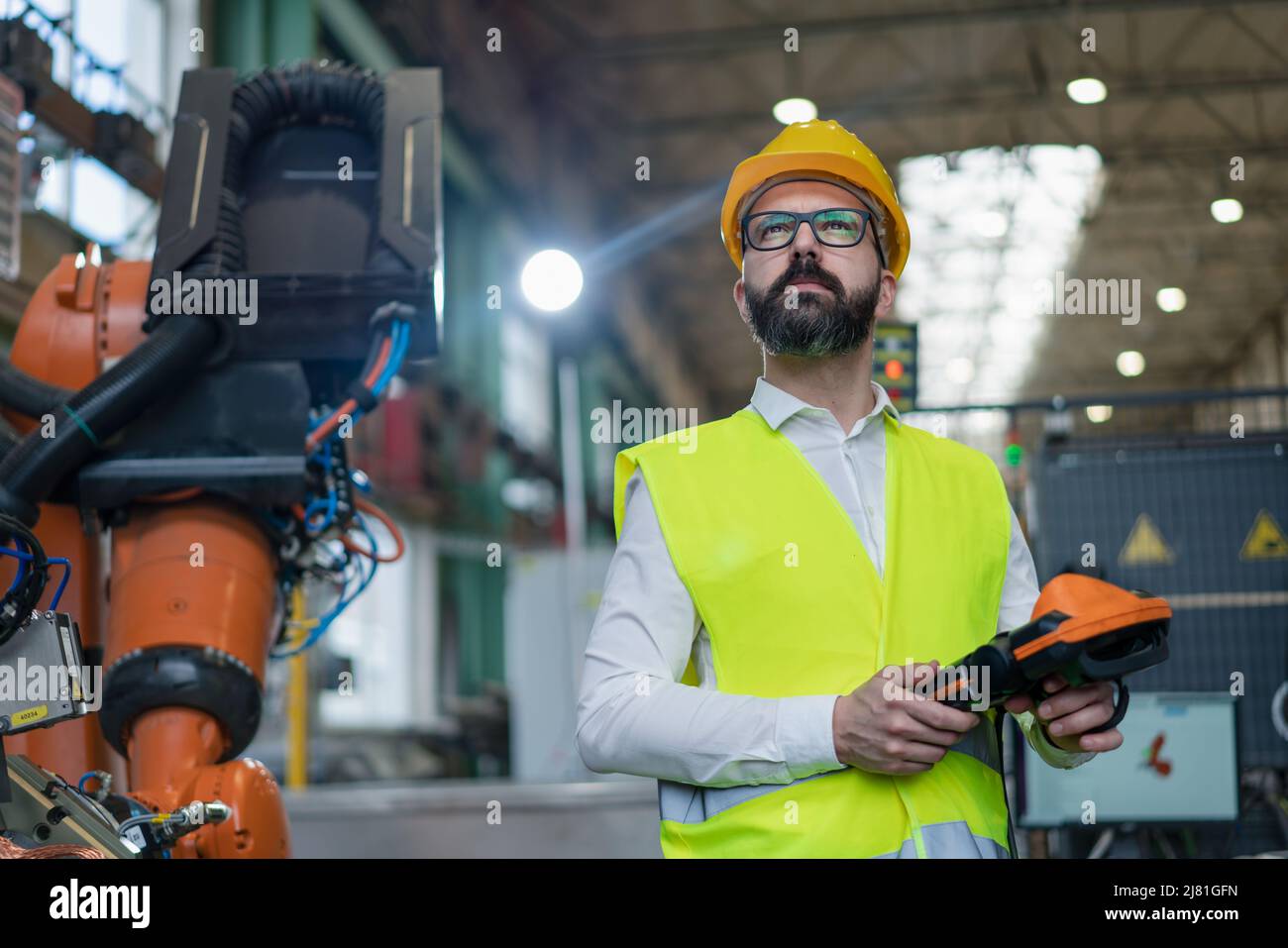 Automation engineer holding scanner in industrial in factory Stock ...