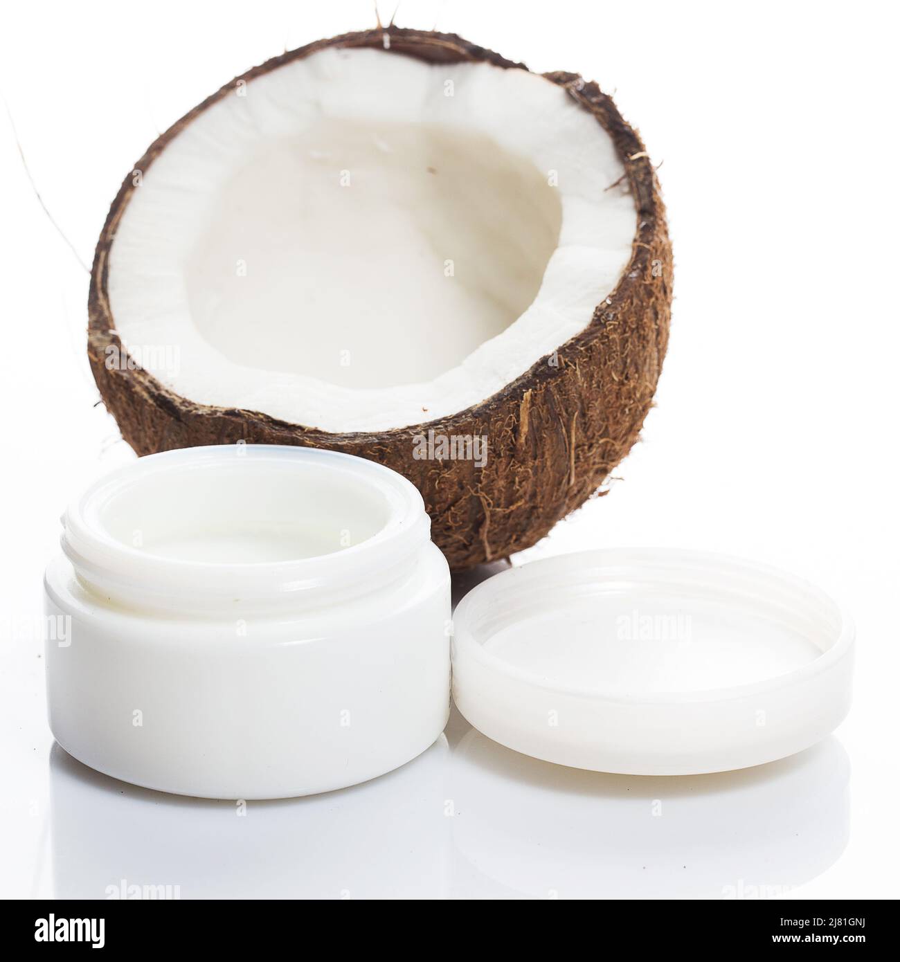 Coconut and moisturizer cream on white background Stock Photo - Alamy