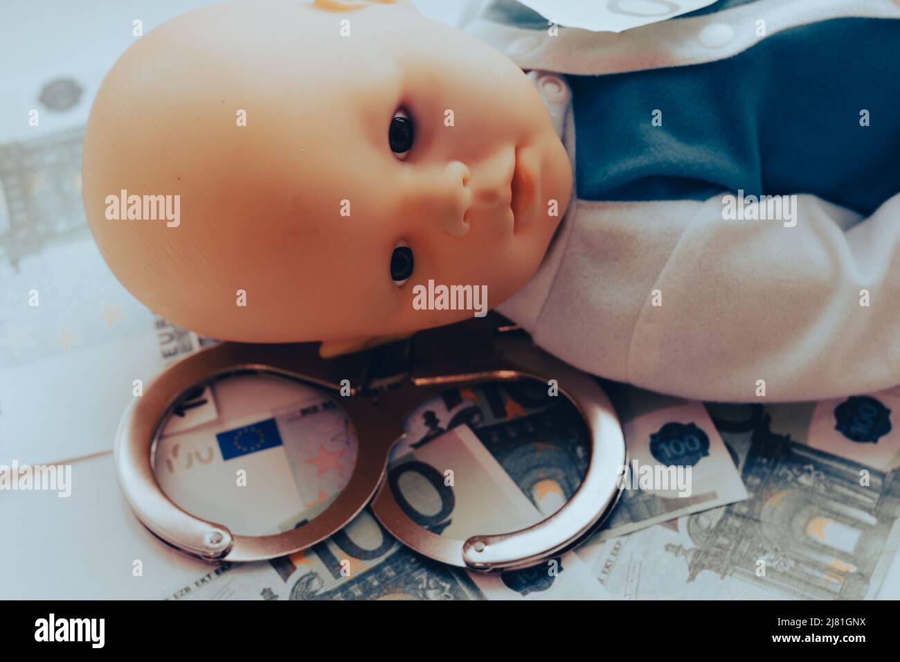 baby doll lies with handcuffs. child crime concept. High quality photo ...