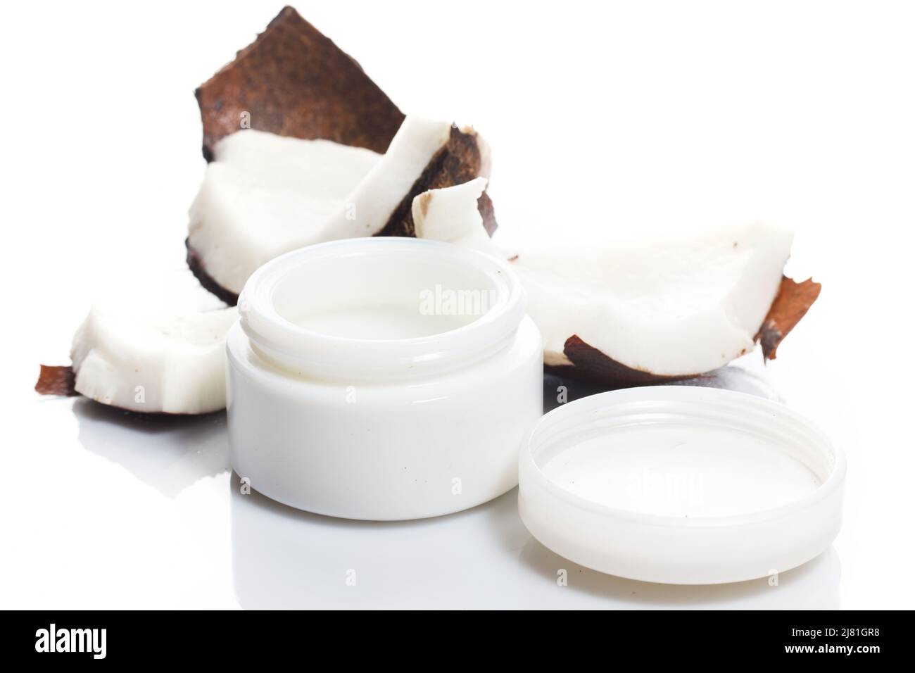Coconut and moisturizer cream on white background Stock Photo - Alamy
