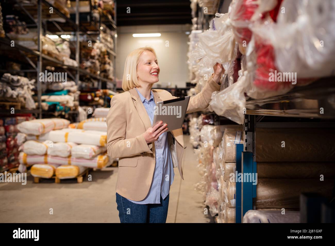 Europe business woman doing inventory at a warehouse using a tablet ...