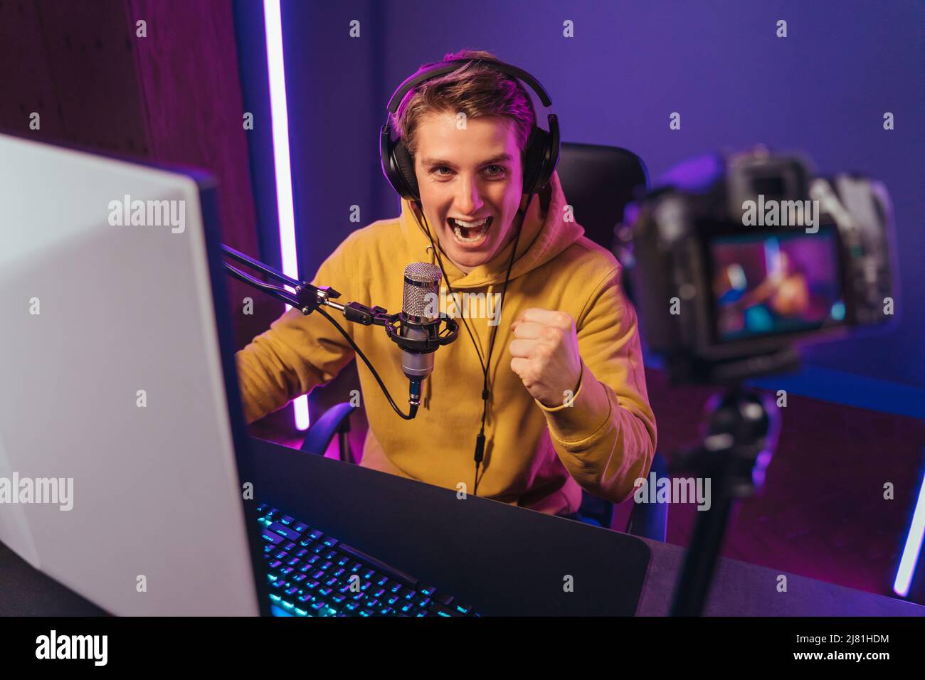 Exited caucasian cyber sportsman shooting vlog, screaming happily on ...