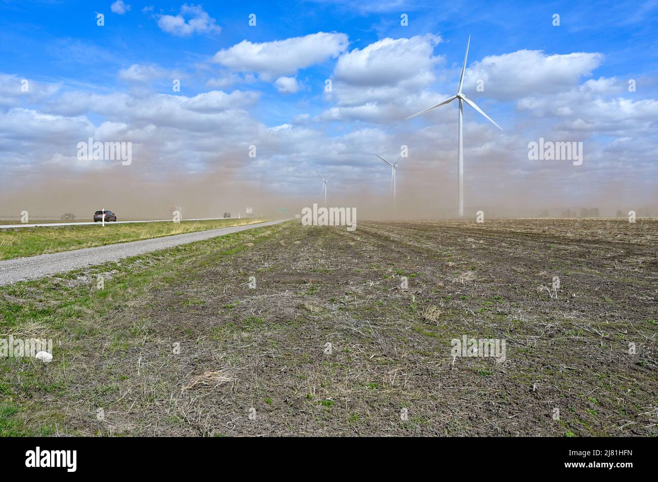 soil and dirt blowing over field with wind turbines Stock Photo - Alamy