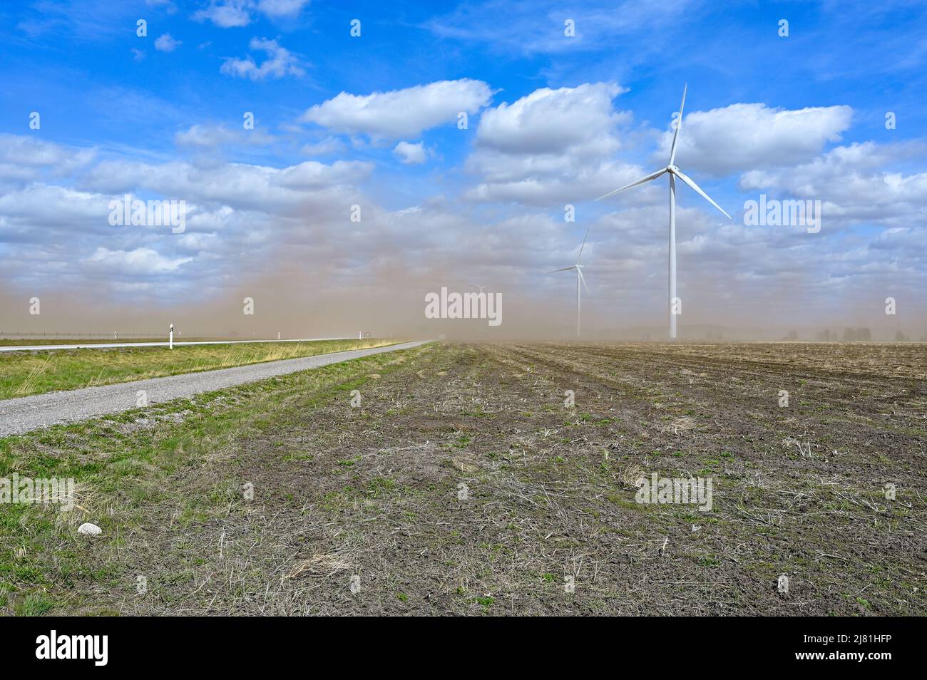 soil and dirt blowing over field with wind turbines Stock Photo - Alamy