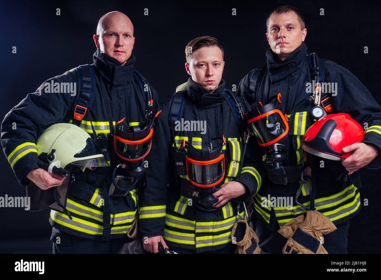 portrait еркуу strong fireman in fireproof uniform holding an ax ...