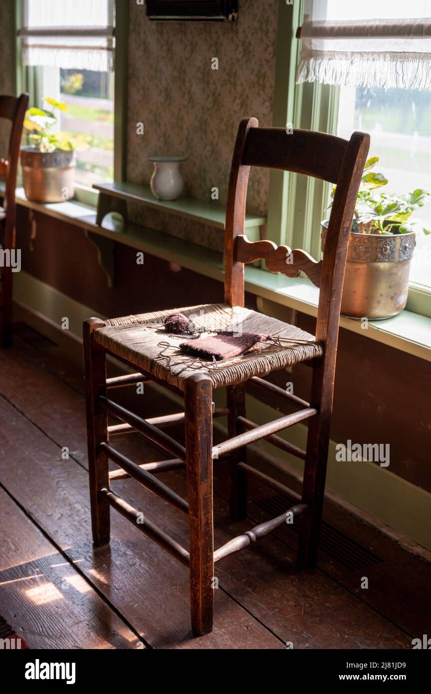 Old fashioned wooden chair in sunlights by window, Dutch interior and ...