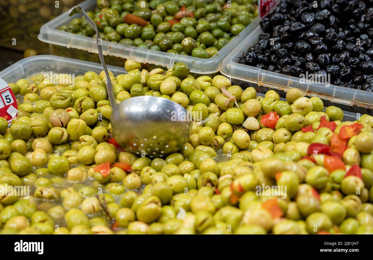 Assortment of ripe pickled green olives on farmers market in Malaga ...