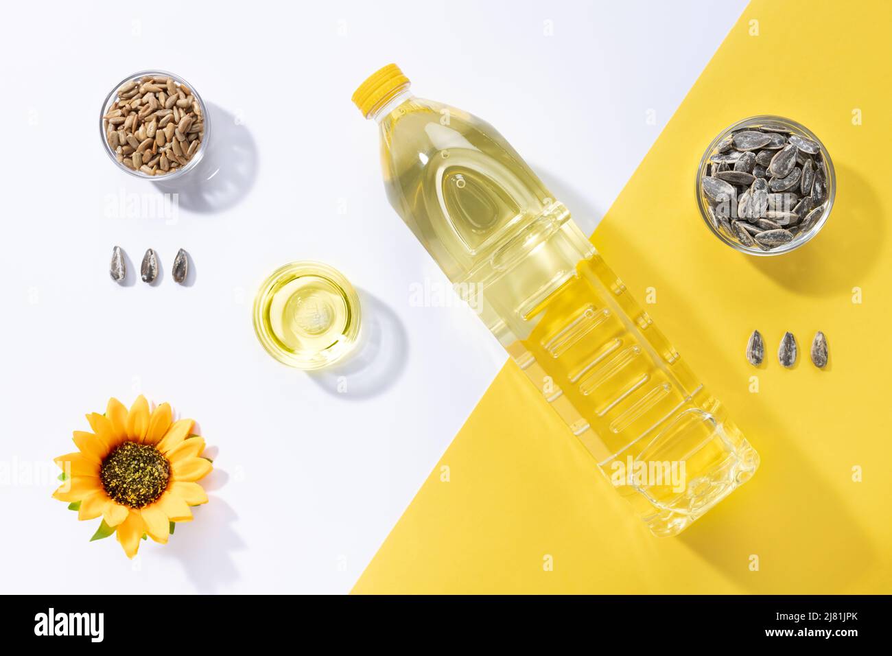 Flat lay composition of sunflower oil with bowls of sunflower seeds on ...