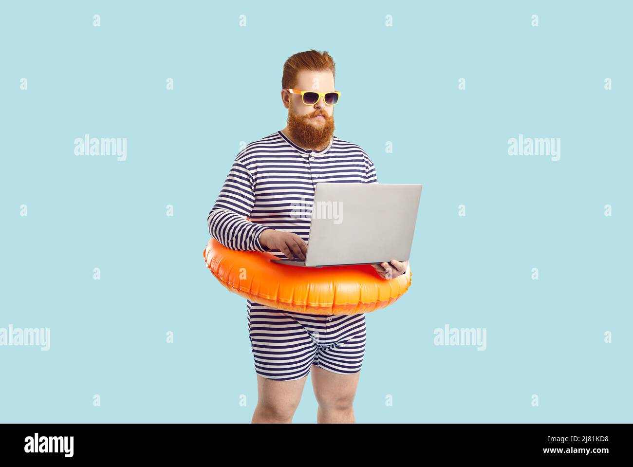 Funny fat businessman working on his laptop computer during summer ...