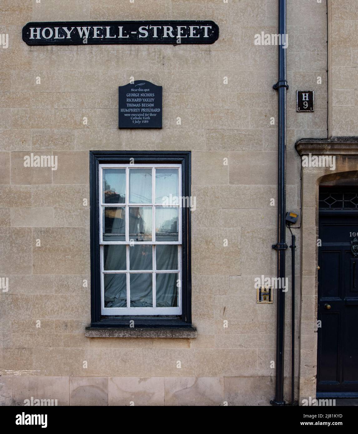 Holywell St in Oxford, UK, with street sign commemorating 16th century ...