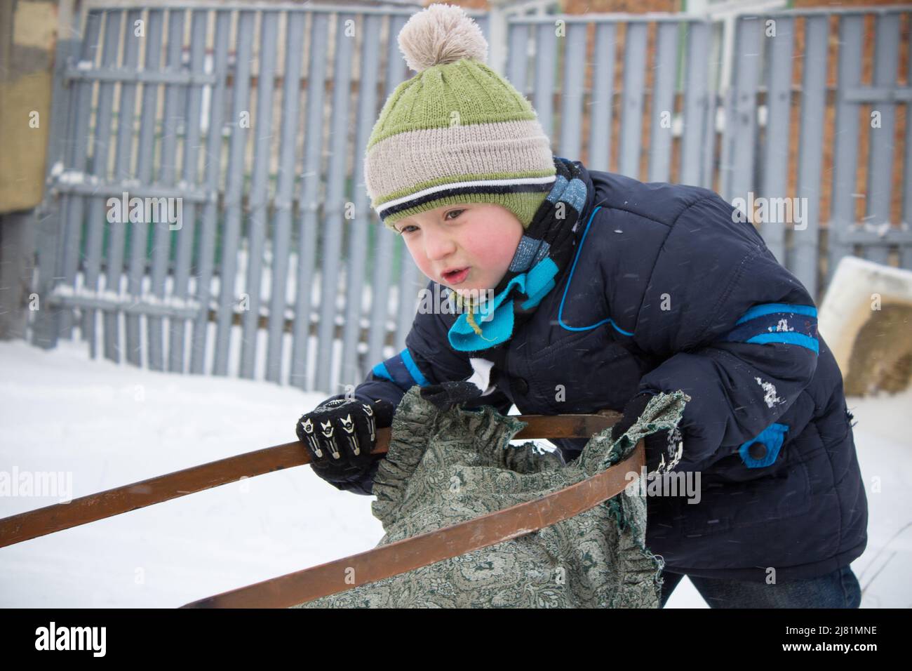 boy pushing sled Stock Photo - Alamy