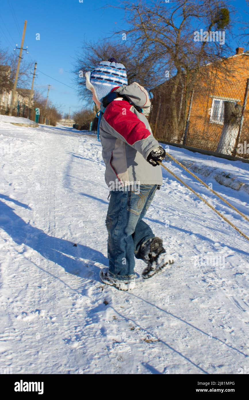 Boys pulling sled hi-res stock photography and images - Alamy
