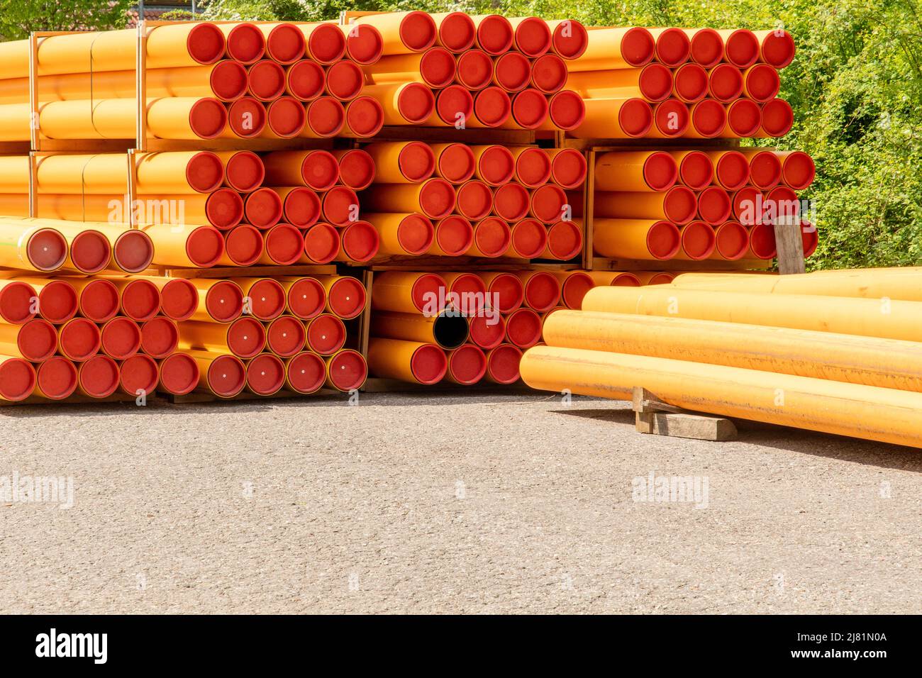 Orange line pipes laid in stock on a construction site Stock Photo - Alamy