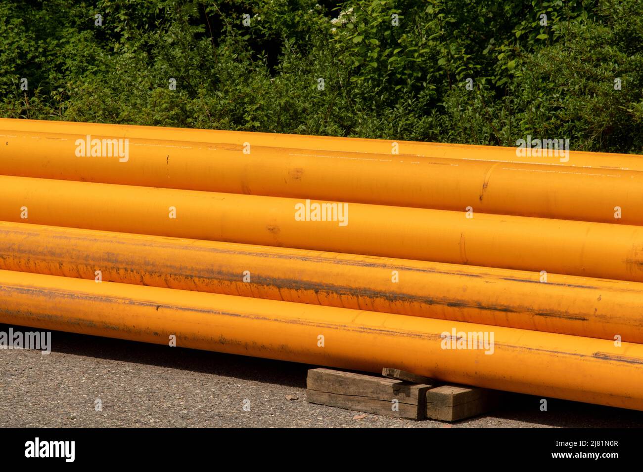 Orange line pipes laid in stock on a construction site Stock Photo - Alamy