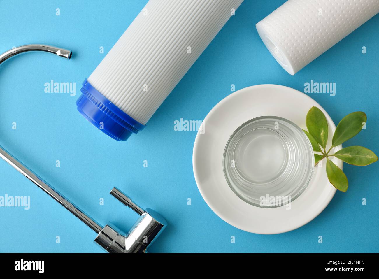 Set of domestic reverse osmosis filters and glass with purified water ...