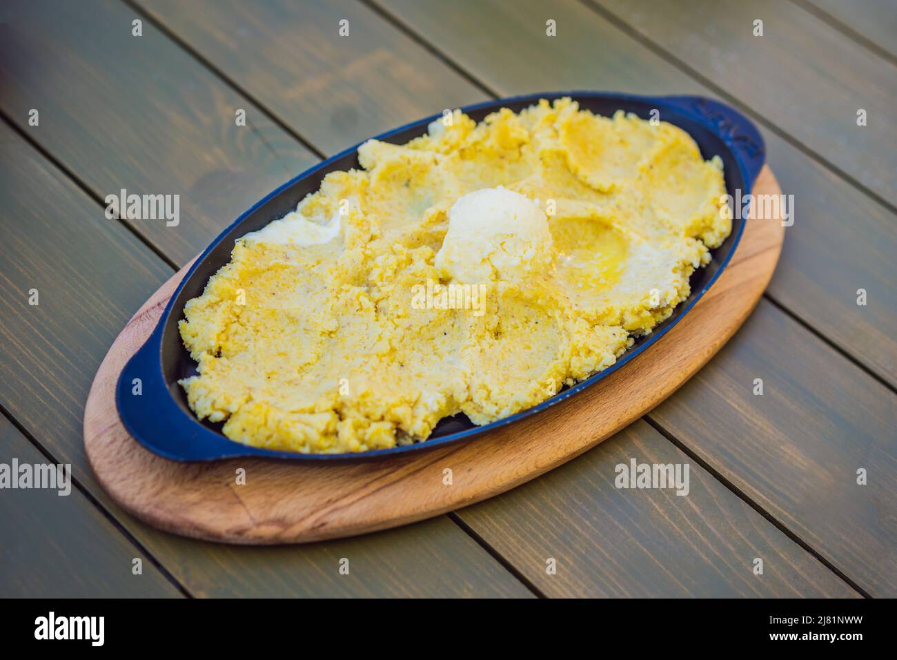 Traditional Montenegrin Meal. Kacamak in a black pan Stock Photo - Alamy