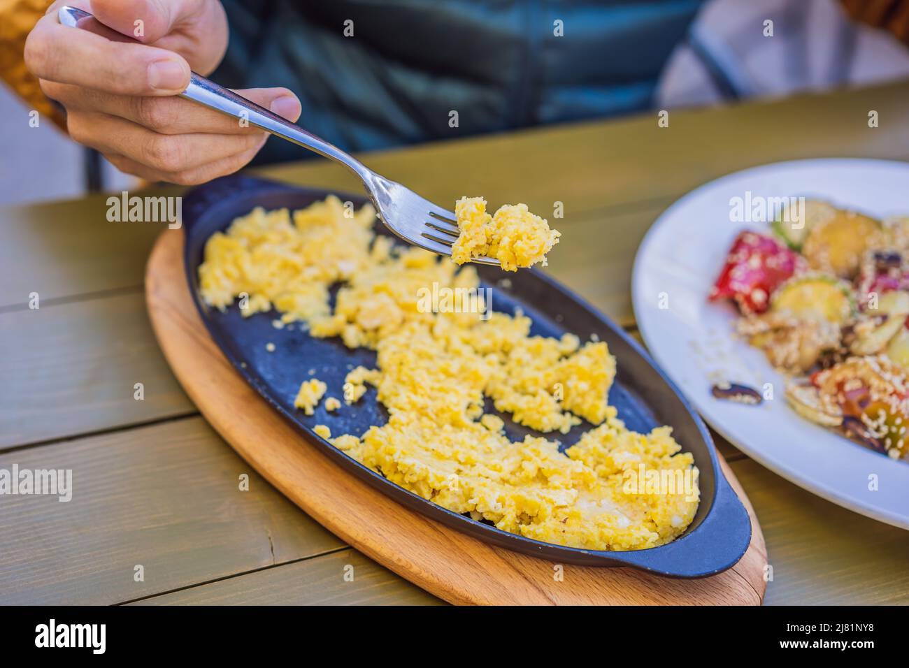 Traditional Montenegrin Meal. Kacamak in a black pan Stock Photo - Alamy