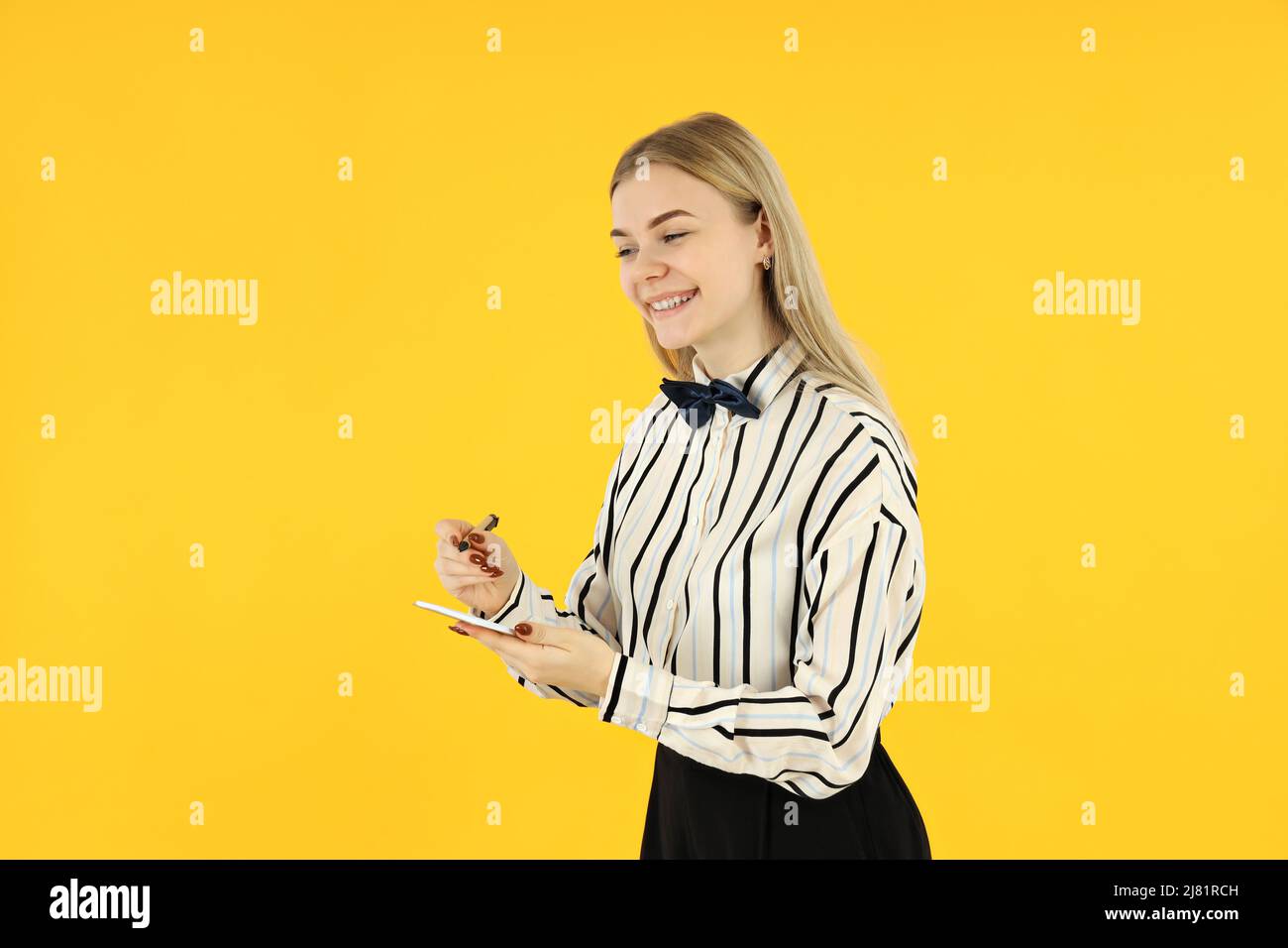 Concept of occupation, young female waiter on yellow background Stock ...