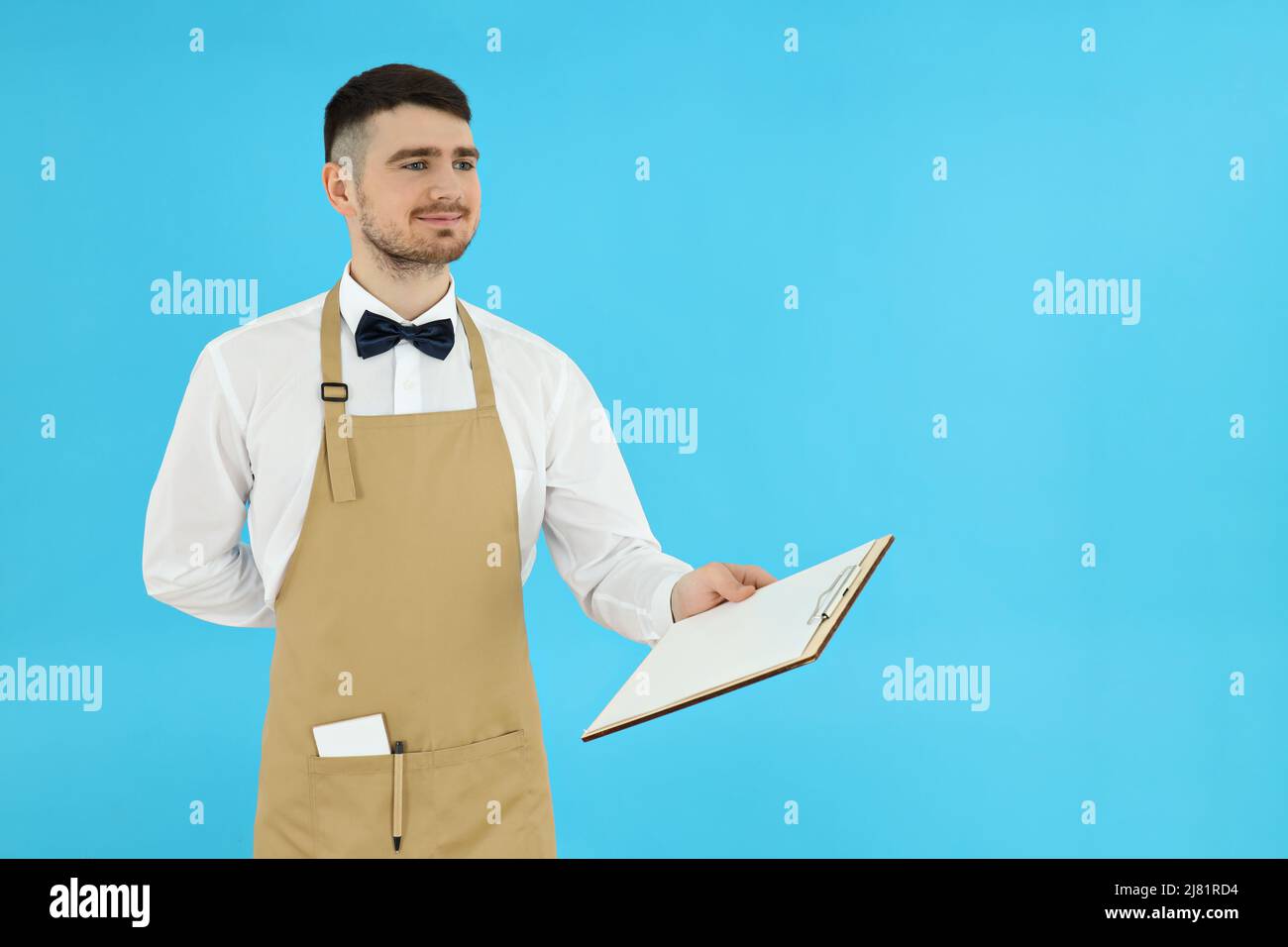 Concept of occupation, young waiter on blue background Stock Photo - Alamy