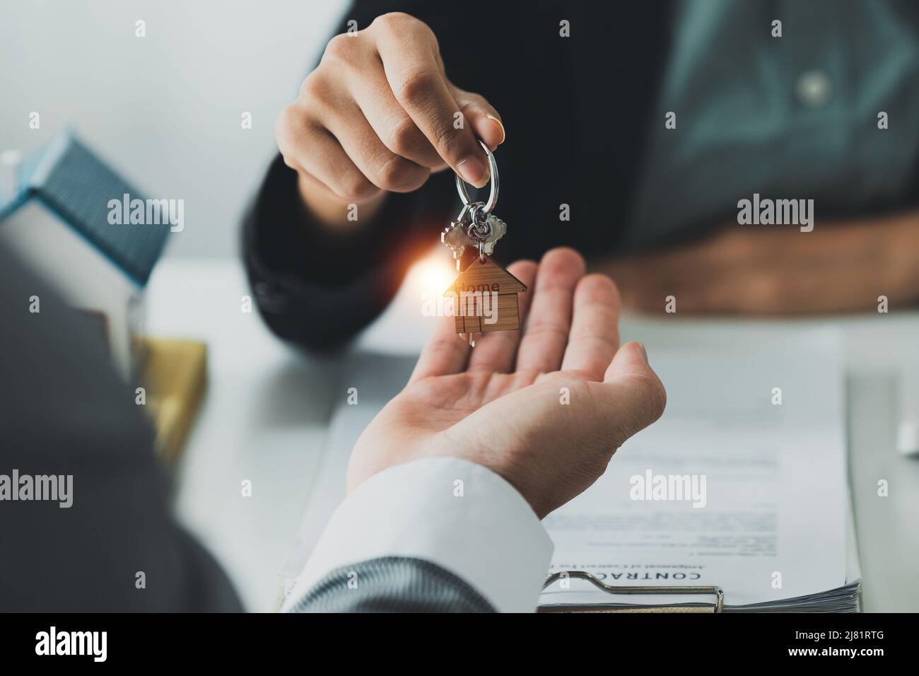 Close up Business woman or Real Estate agent giving house key after ...