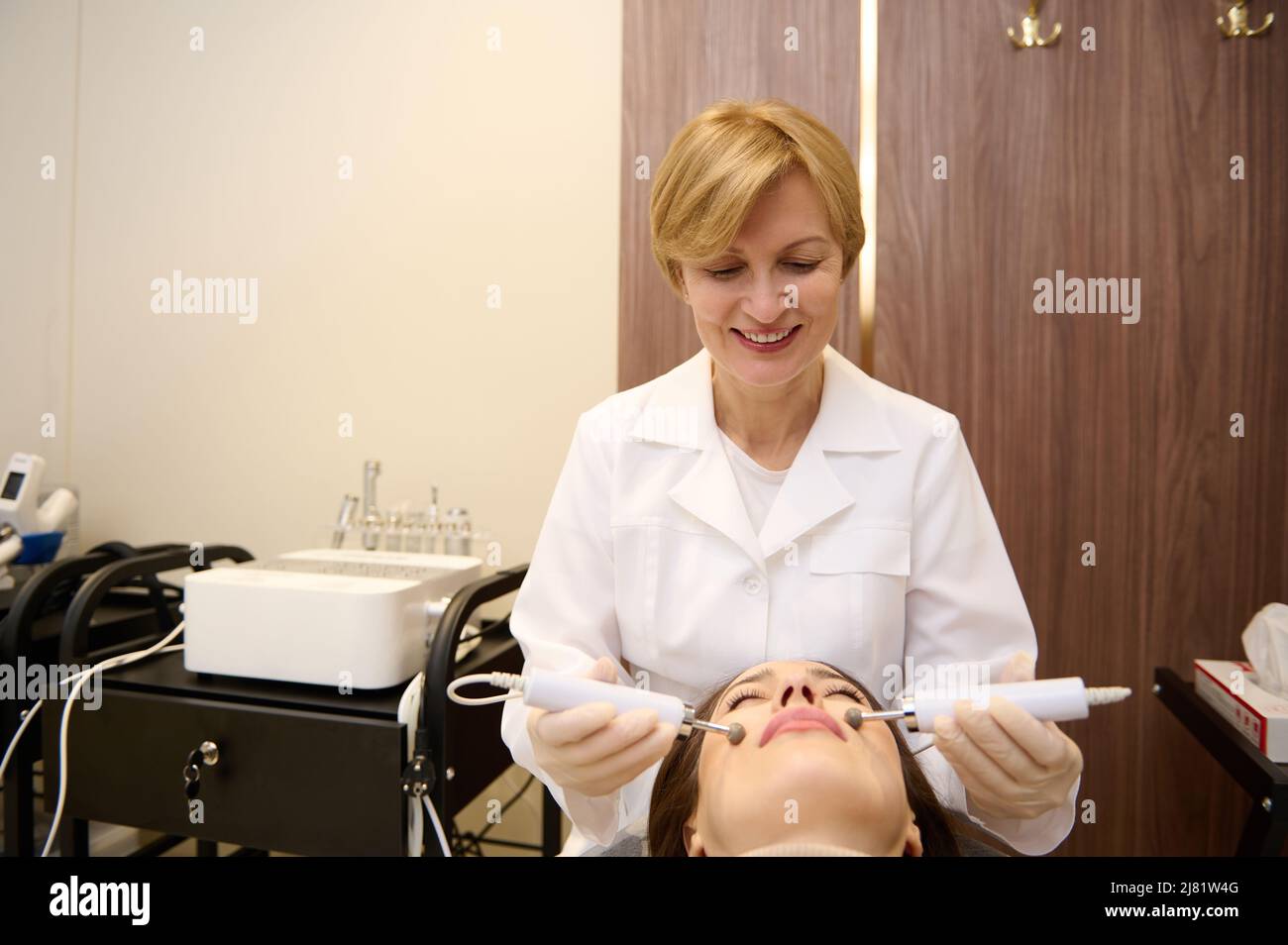 Confident female doctor cosmetologist, aesthetician doing professional ...