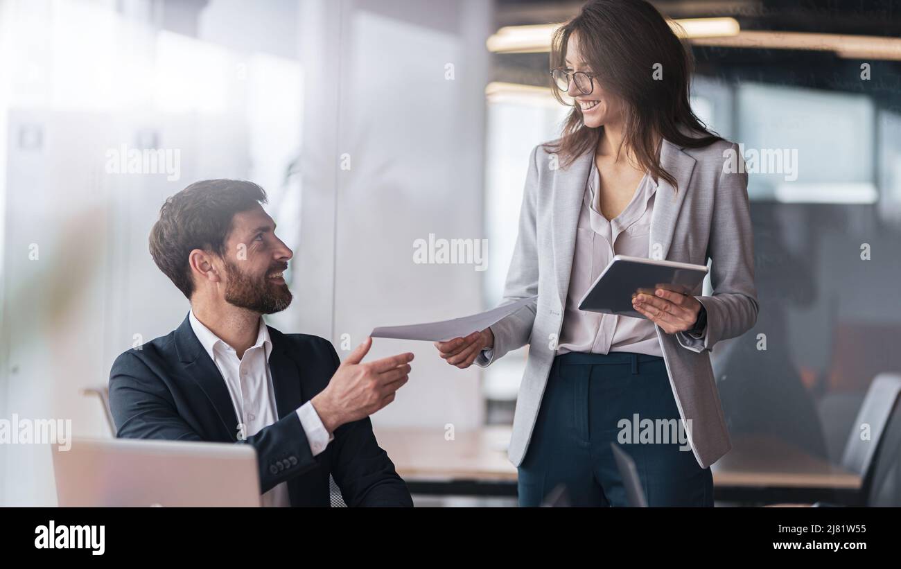Smiling secretary brought the documents to the boss to sign Stock Photo ...