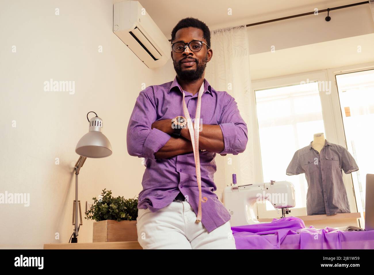 portrait of a handsome african man smiling seamstress with sewing ...