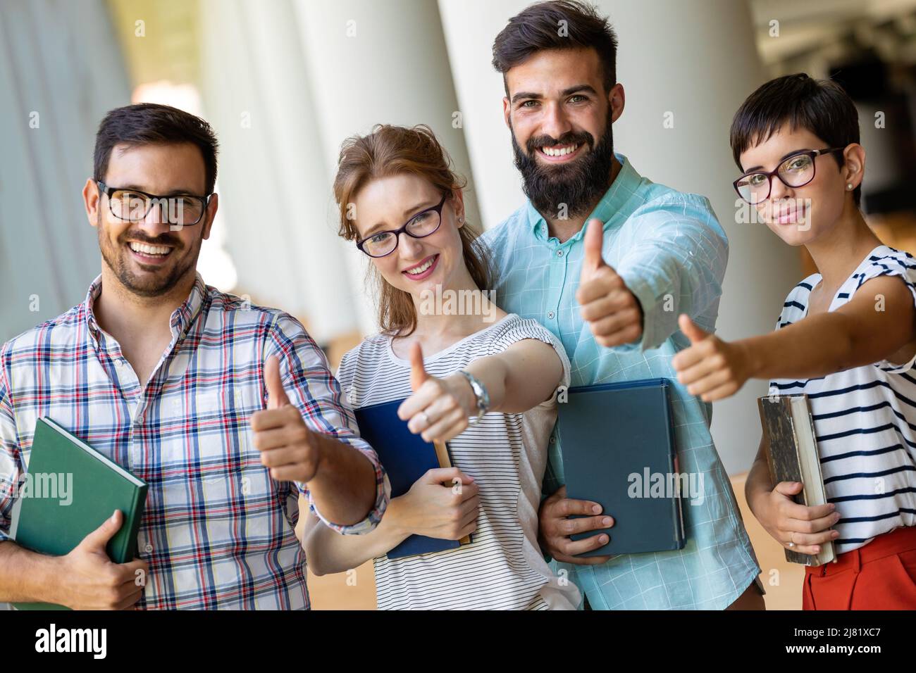 Happy group of success students studying and working together in a ...