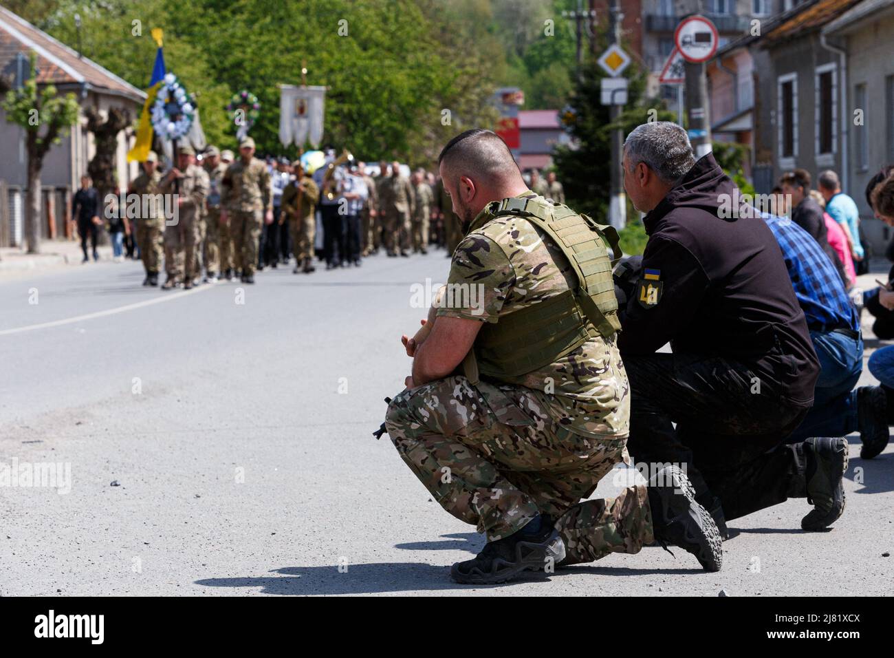 Zakarpatti, Ukraine. May 11, 2022, People kneel before the funeral ...