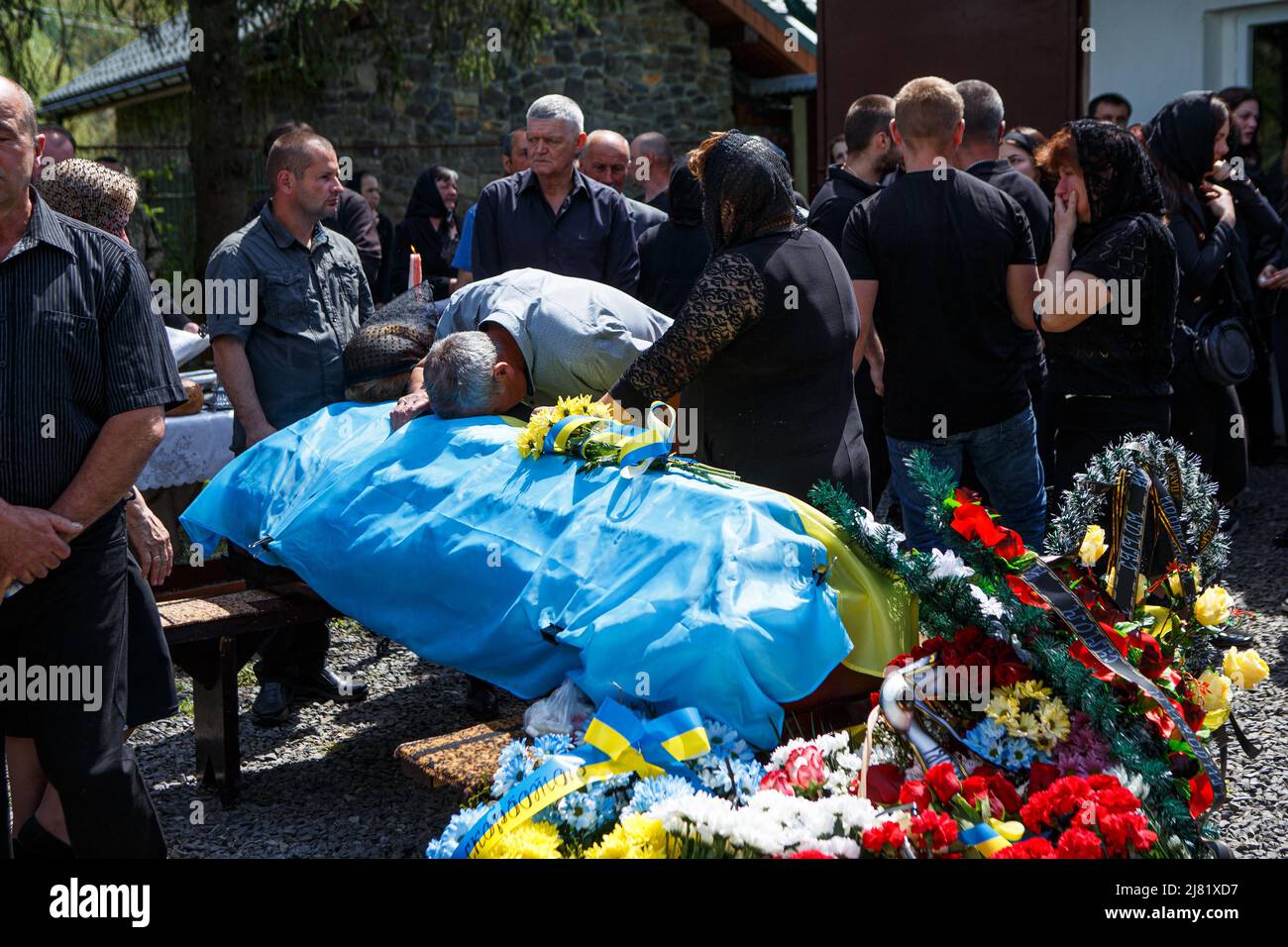 Zakarpatti, Ukraine. May 11, 2022, Family members stay by the coffin ...