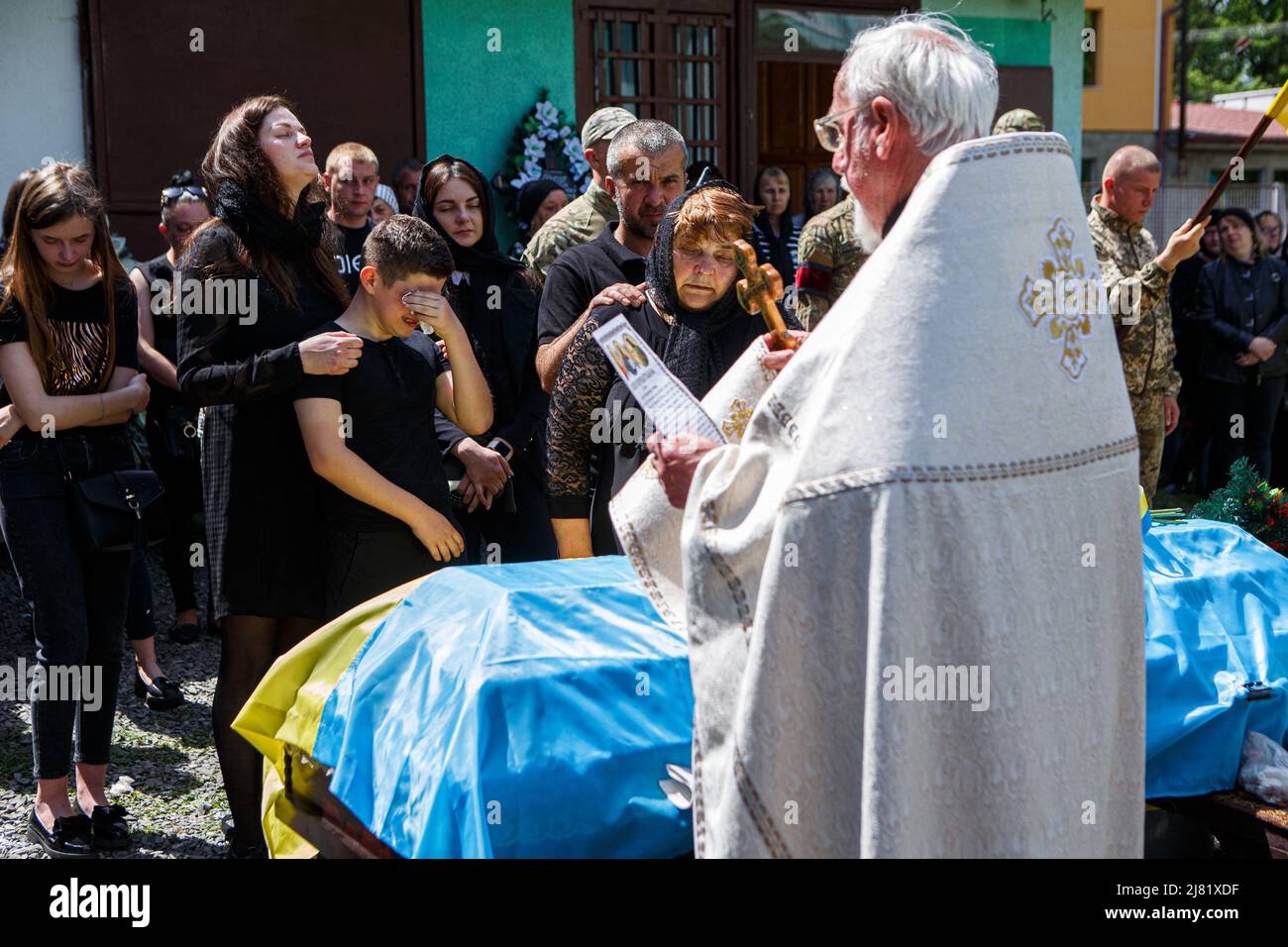 Zakarpatti, Ukraine. May 11, 2022, Family members stay by the coffin ...