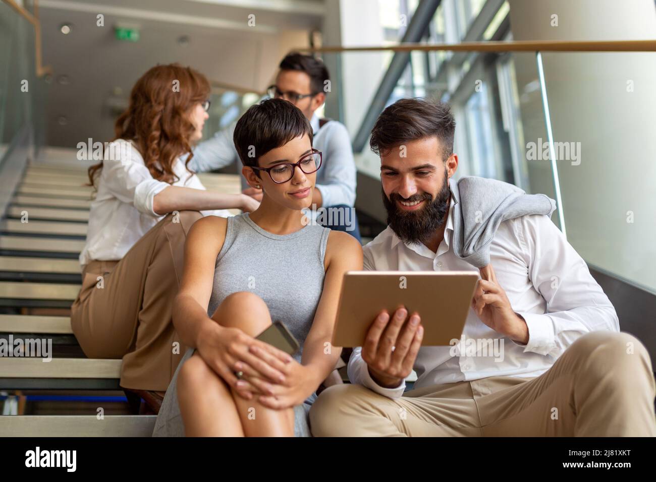 Happy business people, colleagues in modern office working together and ...