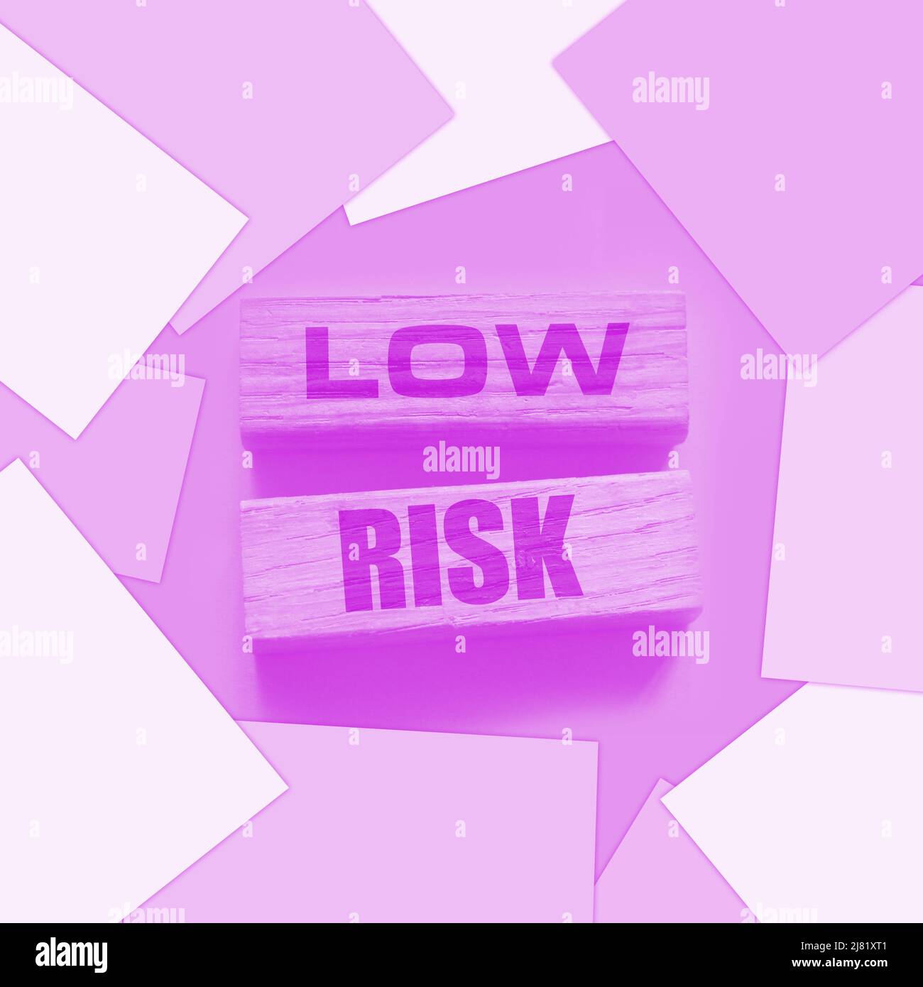Low risk words wooden blocks on yellow. Business investment risks ...