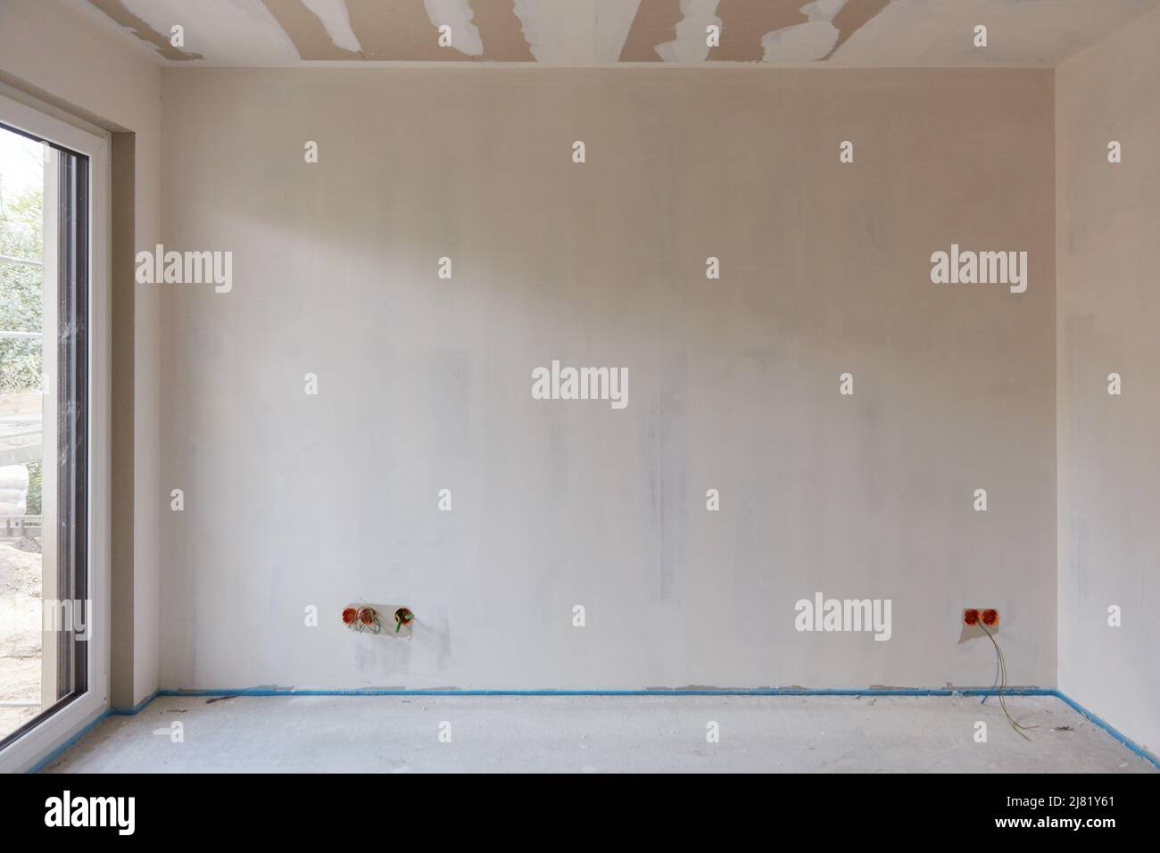 Filling and plastering walls and ceilings in a room during interior ...