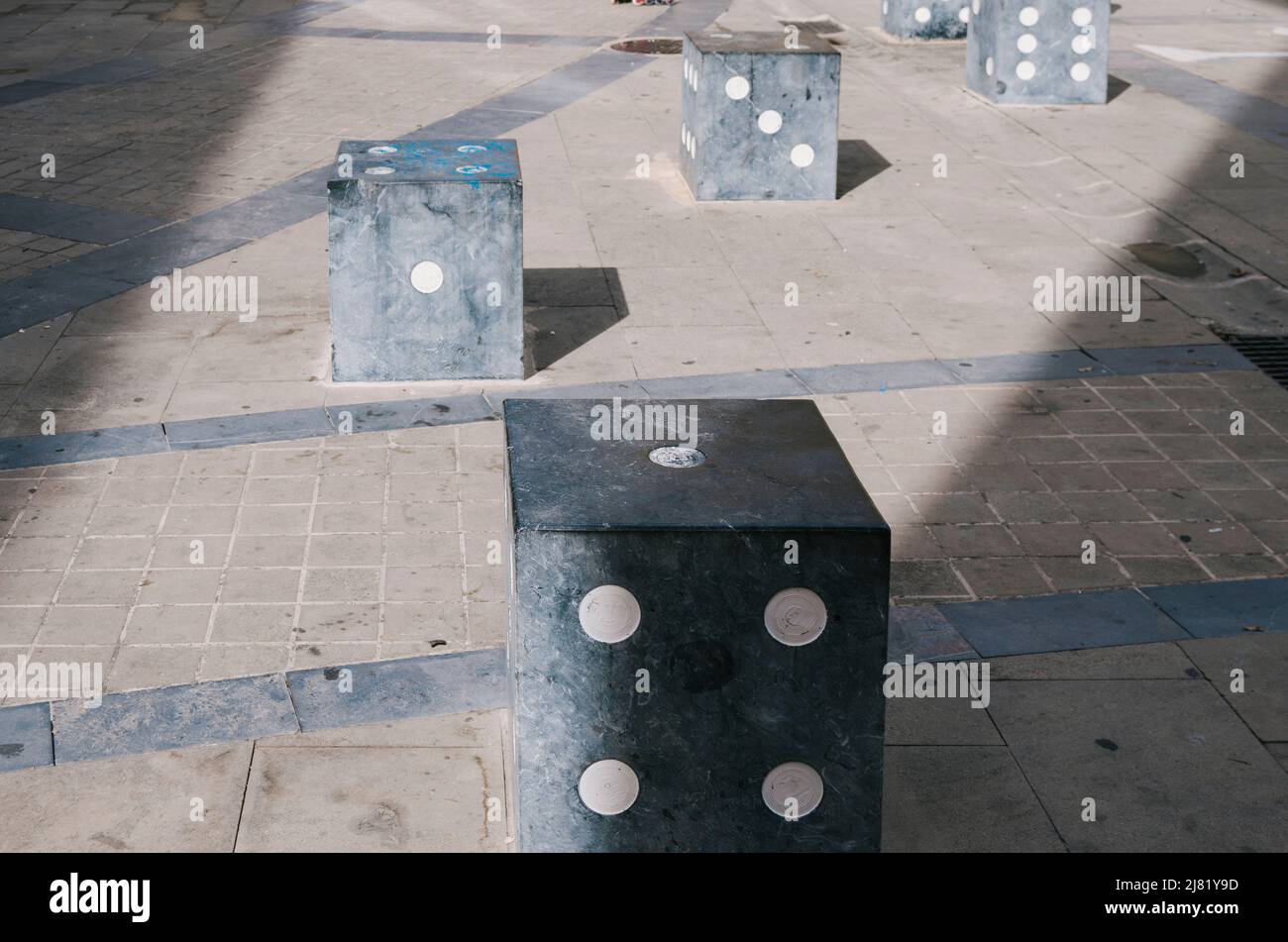 four giant stone cubes in the street as benches Stock Photo - Alamy