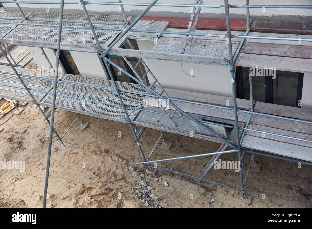 Attaching the scaffolding to the building site for plastering work on ...