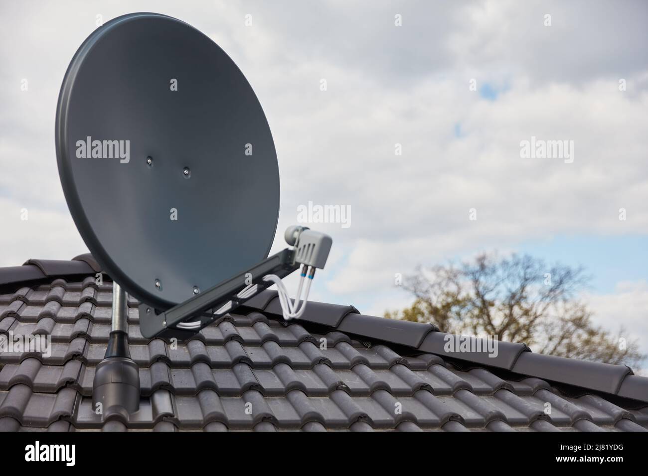 Modern satellite dish on the roof of the house for satellite reception ...