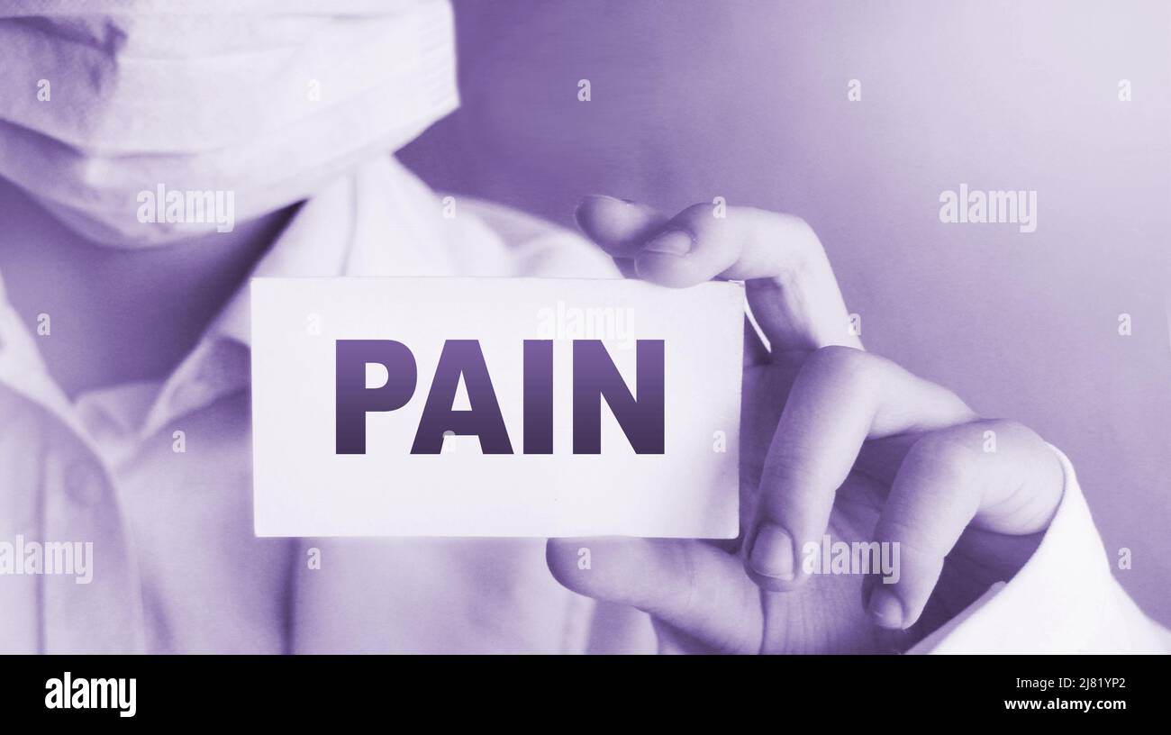 Pain card in hand of Medical Doctor. Healthcare pain relief concept ...