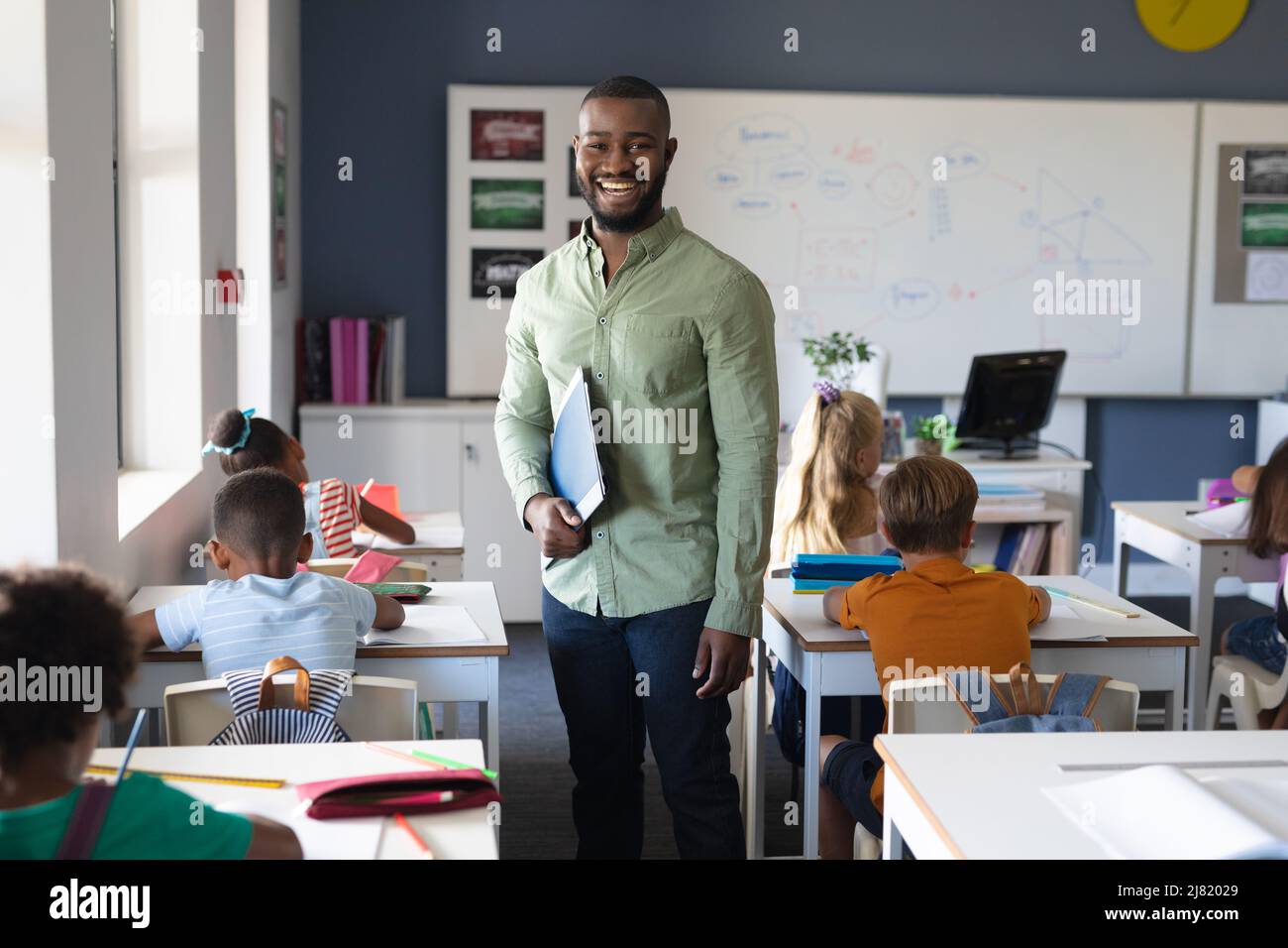 Male teacher standing hi-res stock photography and images - Alamy