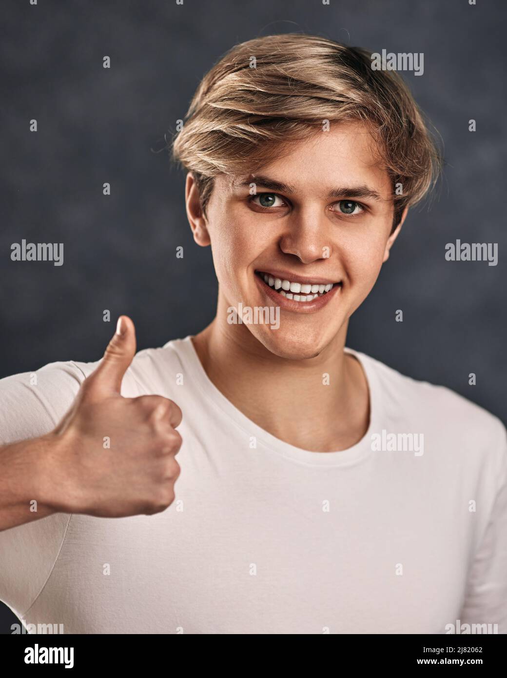 young smiling handsome guy showing Ok gesture Stock Photo - Alamy